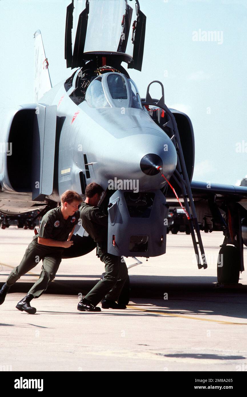 Ground crew personnel work on an RF-4C Phantom II aircraft competing in ...