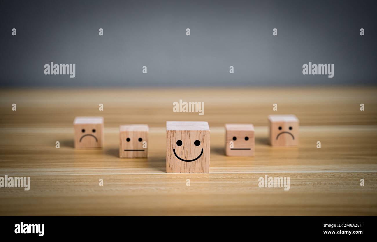 Smiling faces on wooden blocks. Feedback, emotion face symbol Service ...