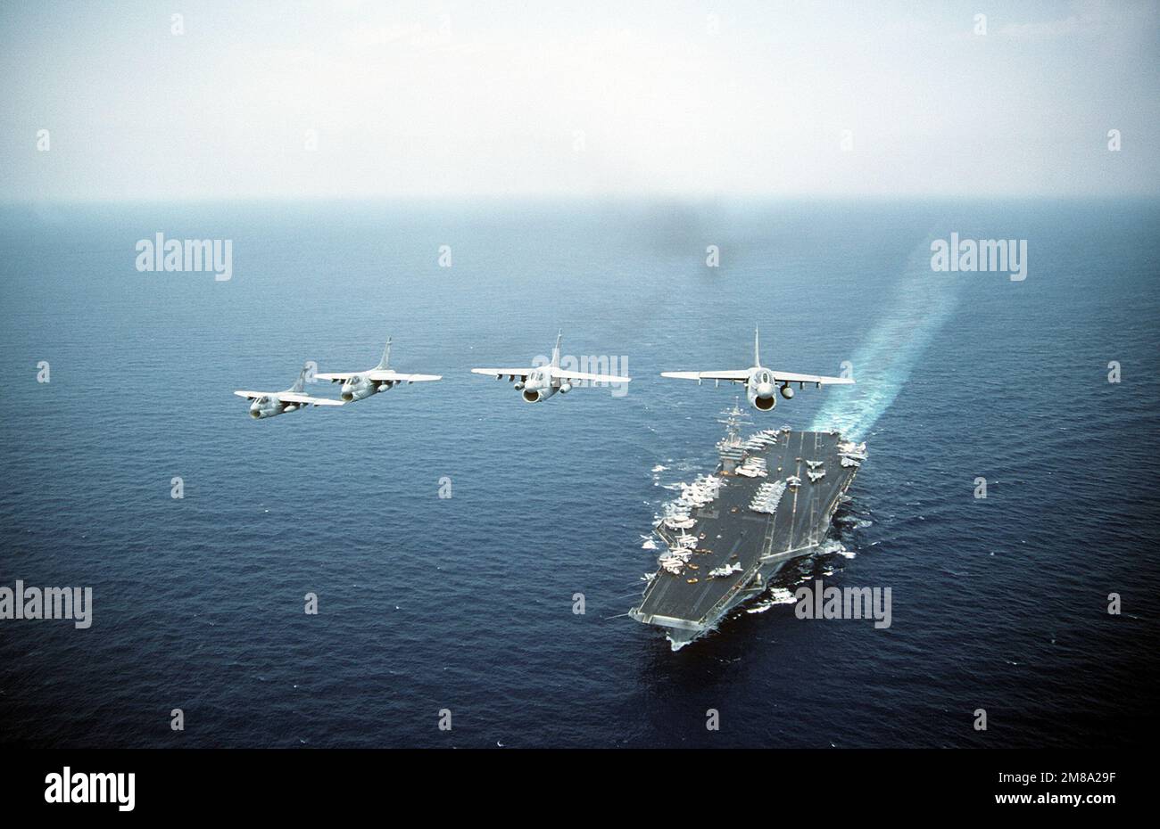 An air-to-air front view of a flight of four A-7E Corsair aircraft from ...