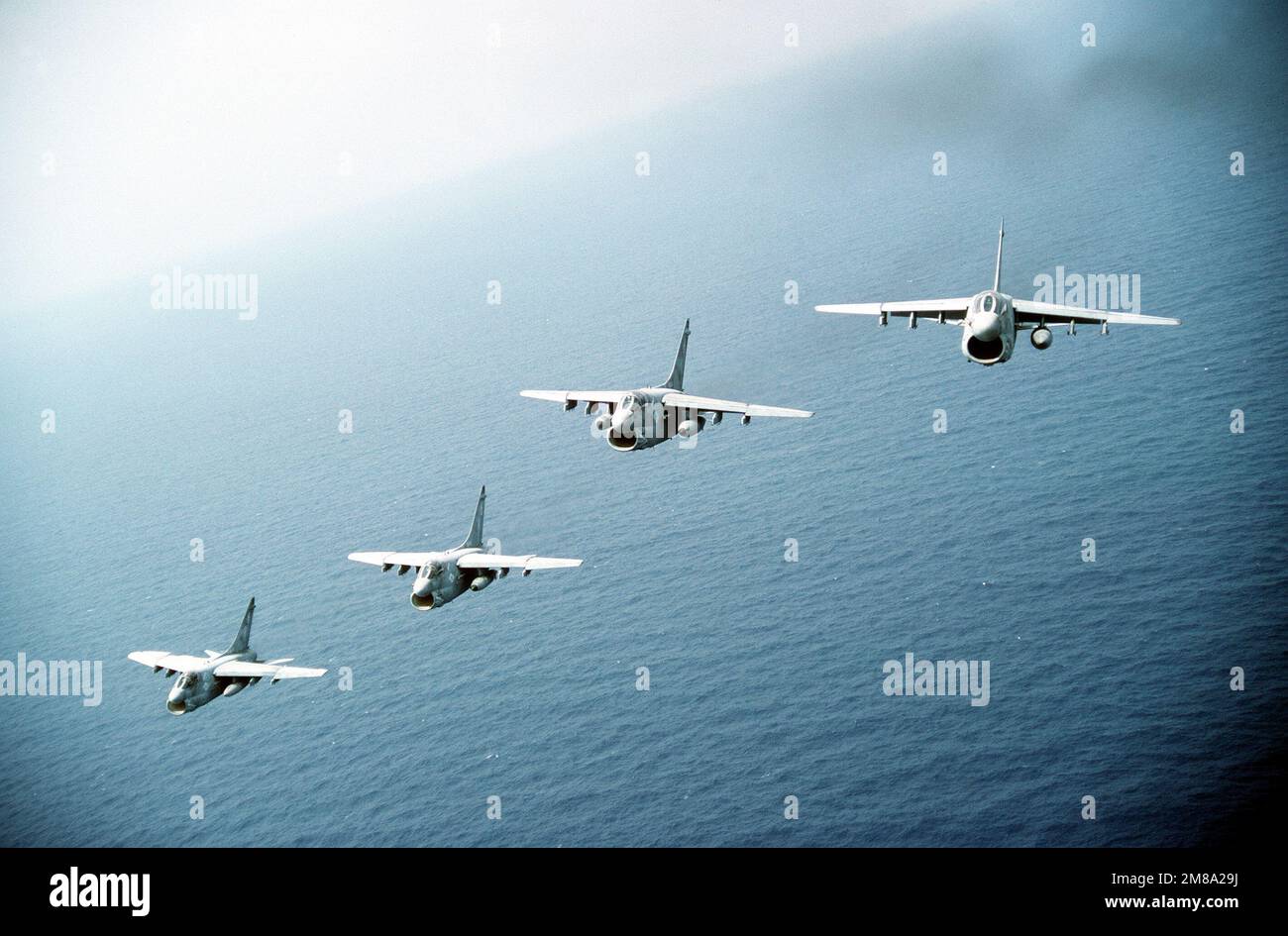 An air-to-air front view of a flight of four A-7E Corsair aircraft from ...