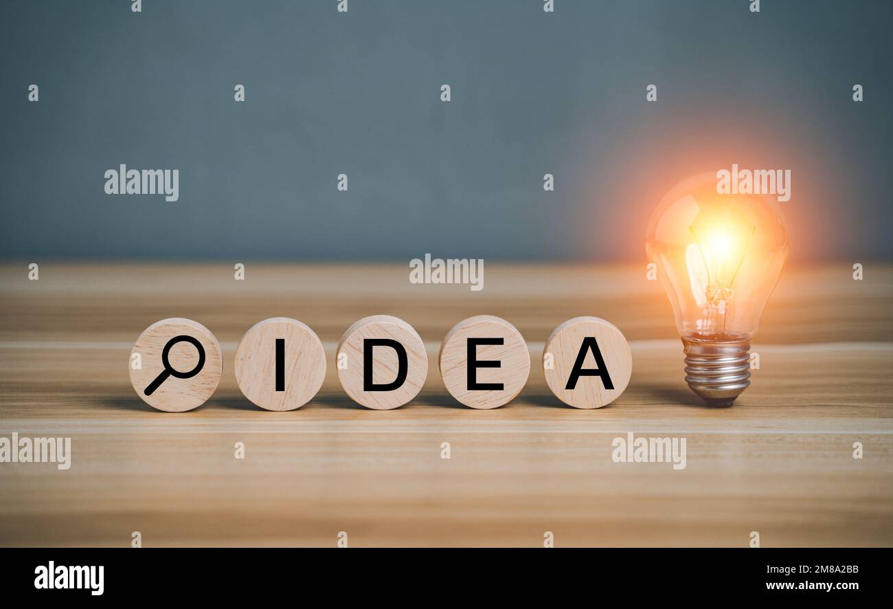 Idea text and find symbol on circular wooden block with shining ...