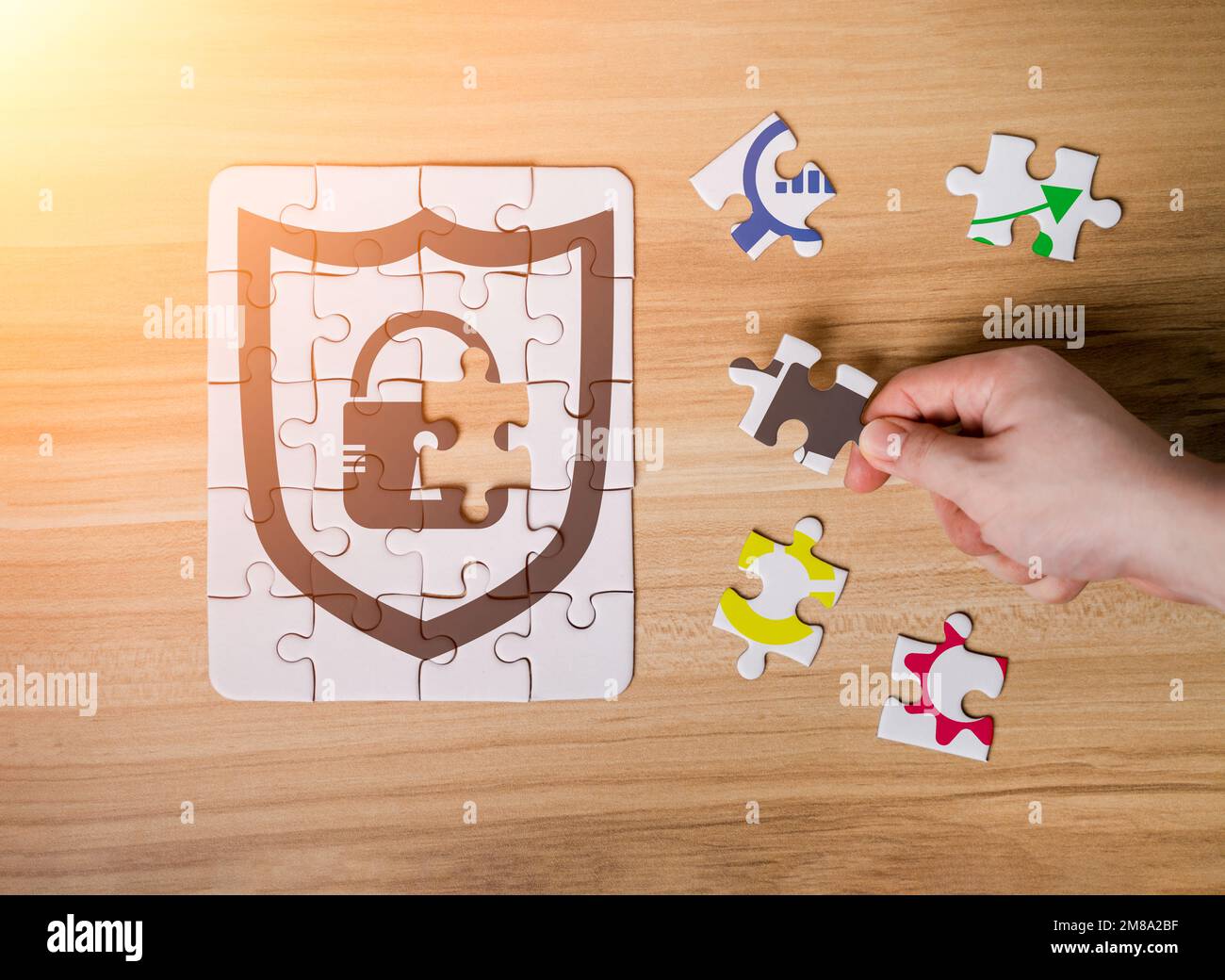 The cybersecurity symbol on missing puzzle piece with wood background ...