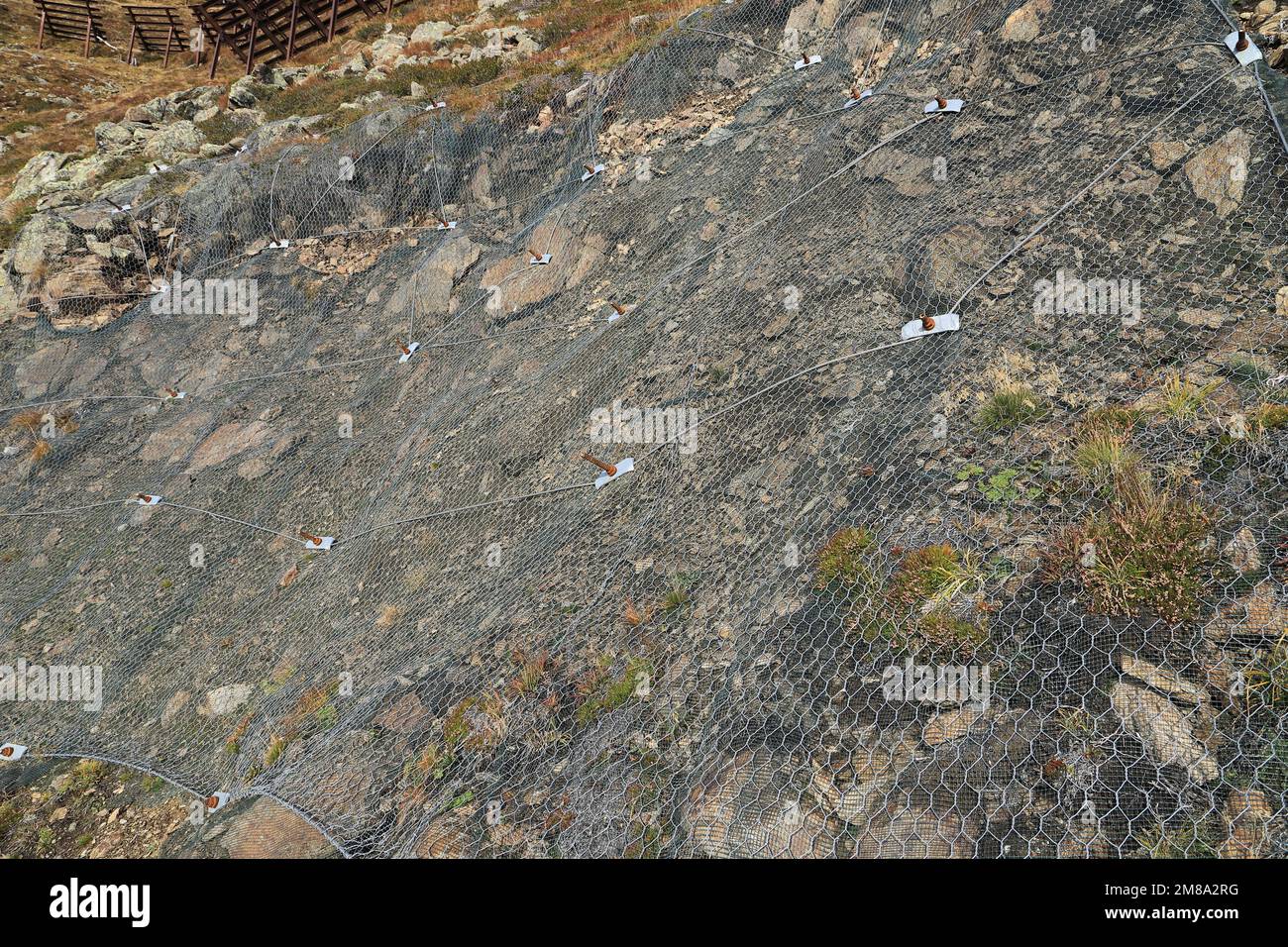 a steel net as security against falling rocks Stock Photo - Alamy