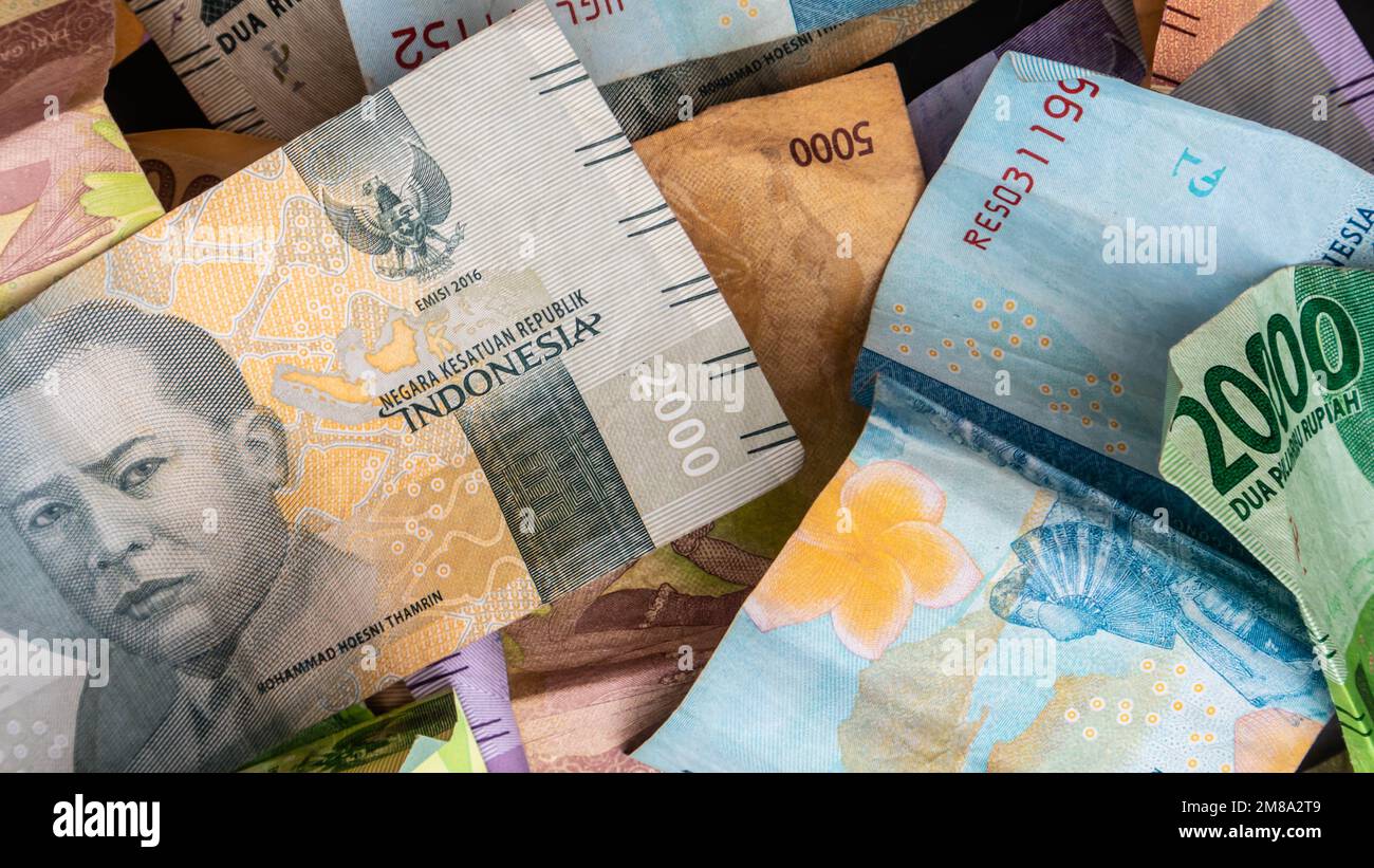 pile of rupiah banknotes as background Stock Photo - Alamy