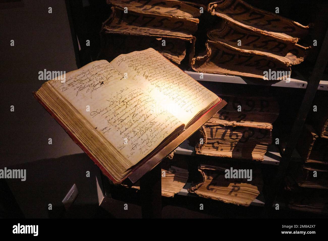 A view of a typical, open, yellowed, sepia bank record book. At the ...
