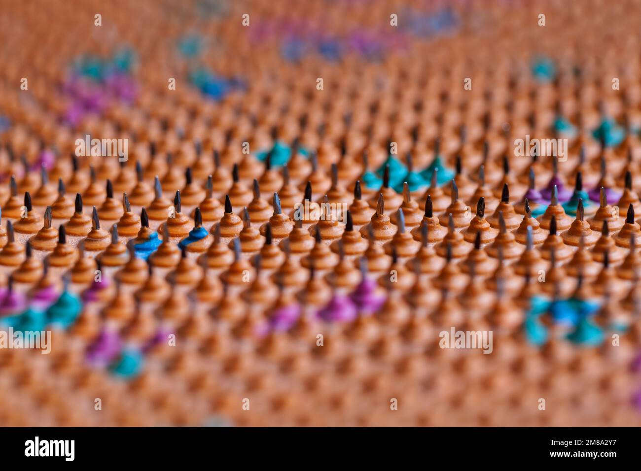 Back applicator with steel spikes in a rubber mat. Close up photo with ...
