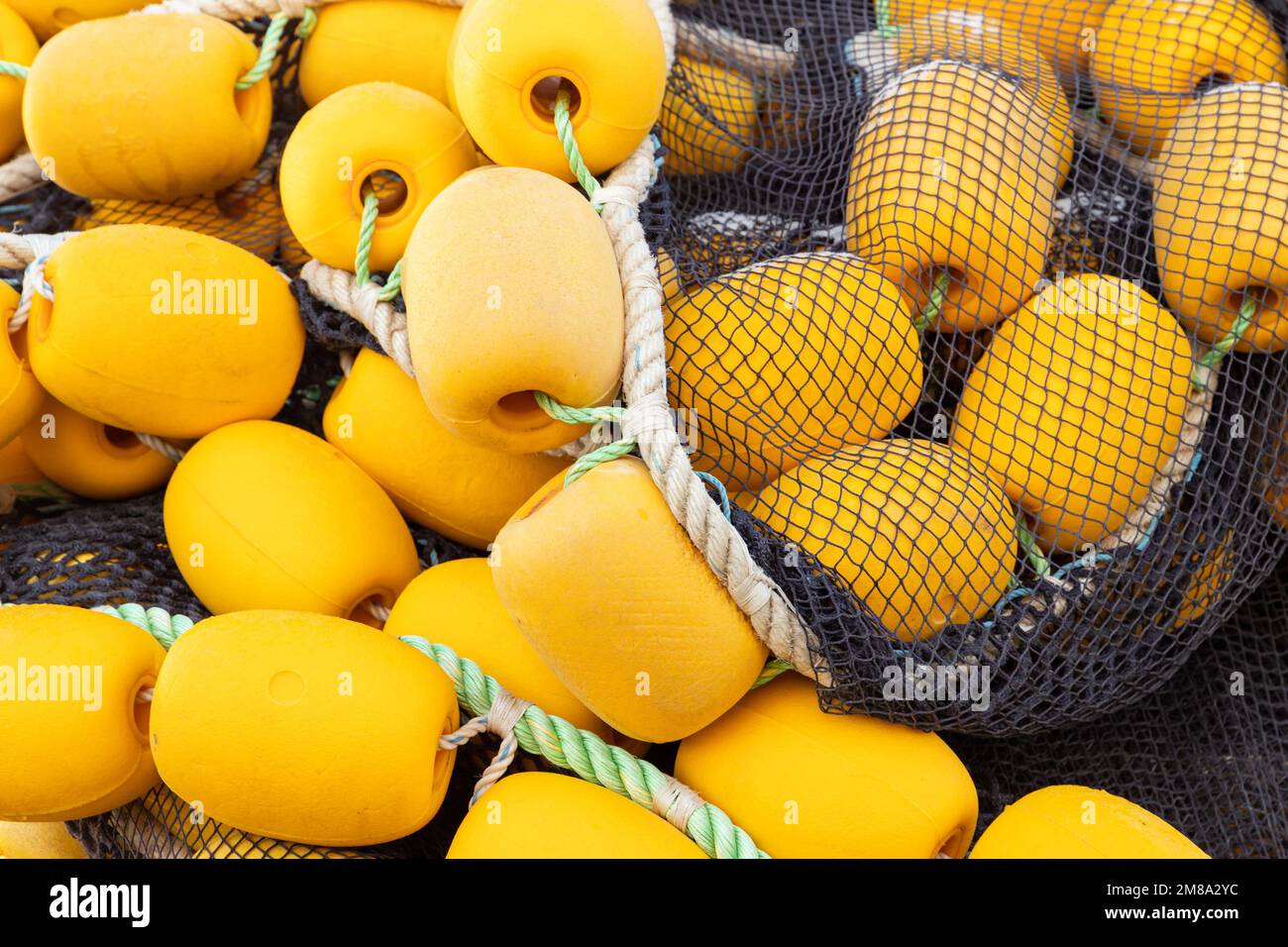 Drying fishing nets with bright yellow floats. Background photo Stock Photo - Alamy
