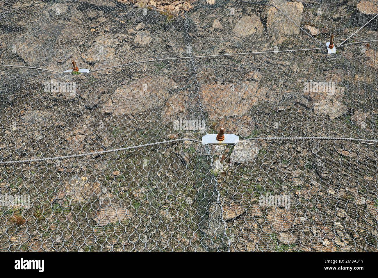 a steel net as security against falling rocks Stock Photo - Alamy