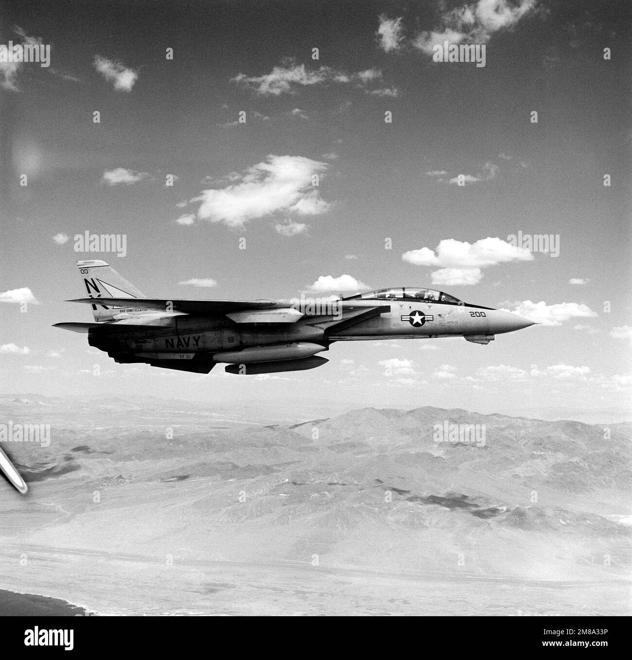 A Fighter Squadron 21 (VF-21) F-14A Tomcat aircraft flies over the ...
