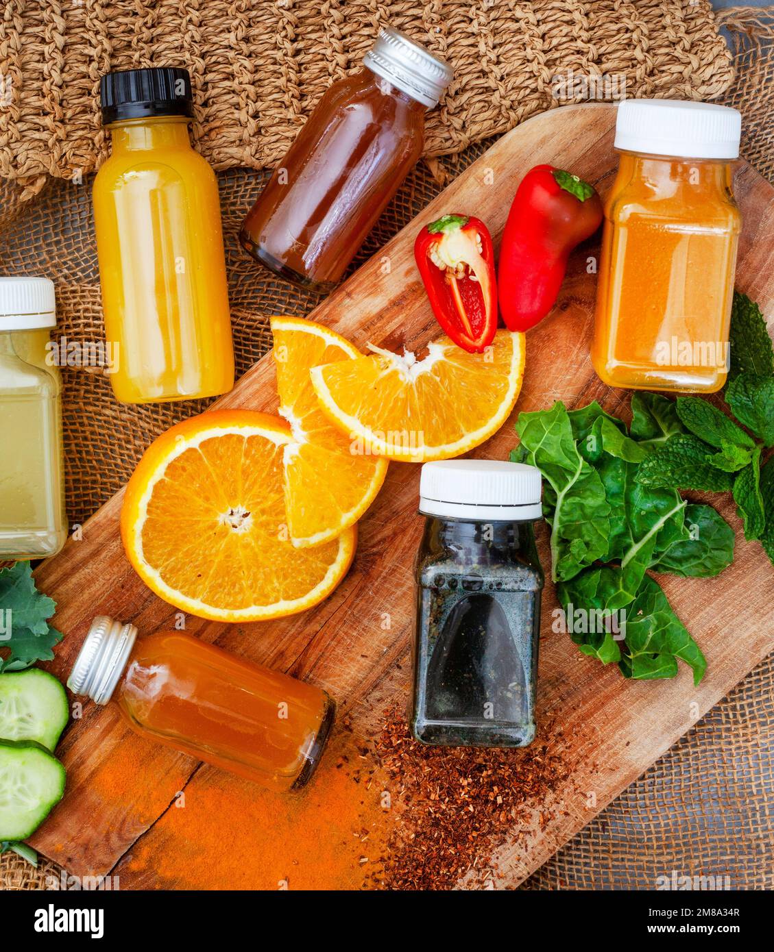 Juice shots for a healthy lifestyle, flat lay on rustic surface with ...