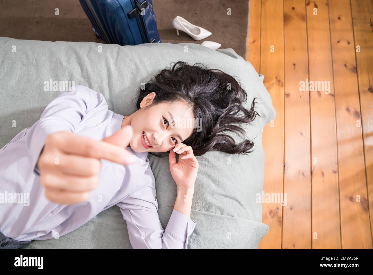 Young woman lying in bed Stock Photo - Alamy