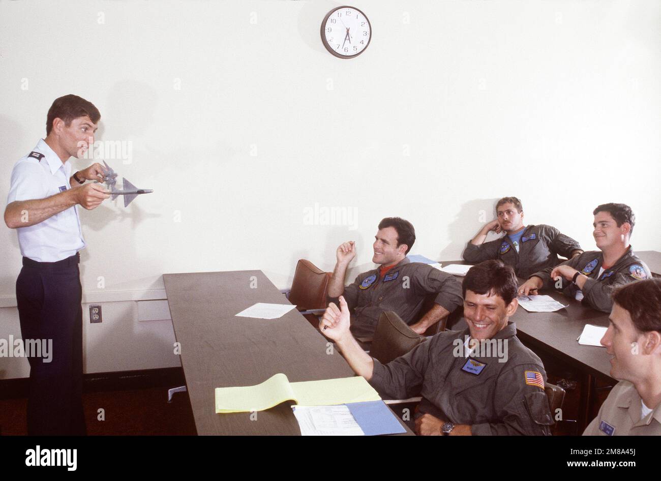 Air Force CAPT. Ronald "Taco" Johnson uses model airplanes to teach a ...
