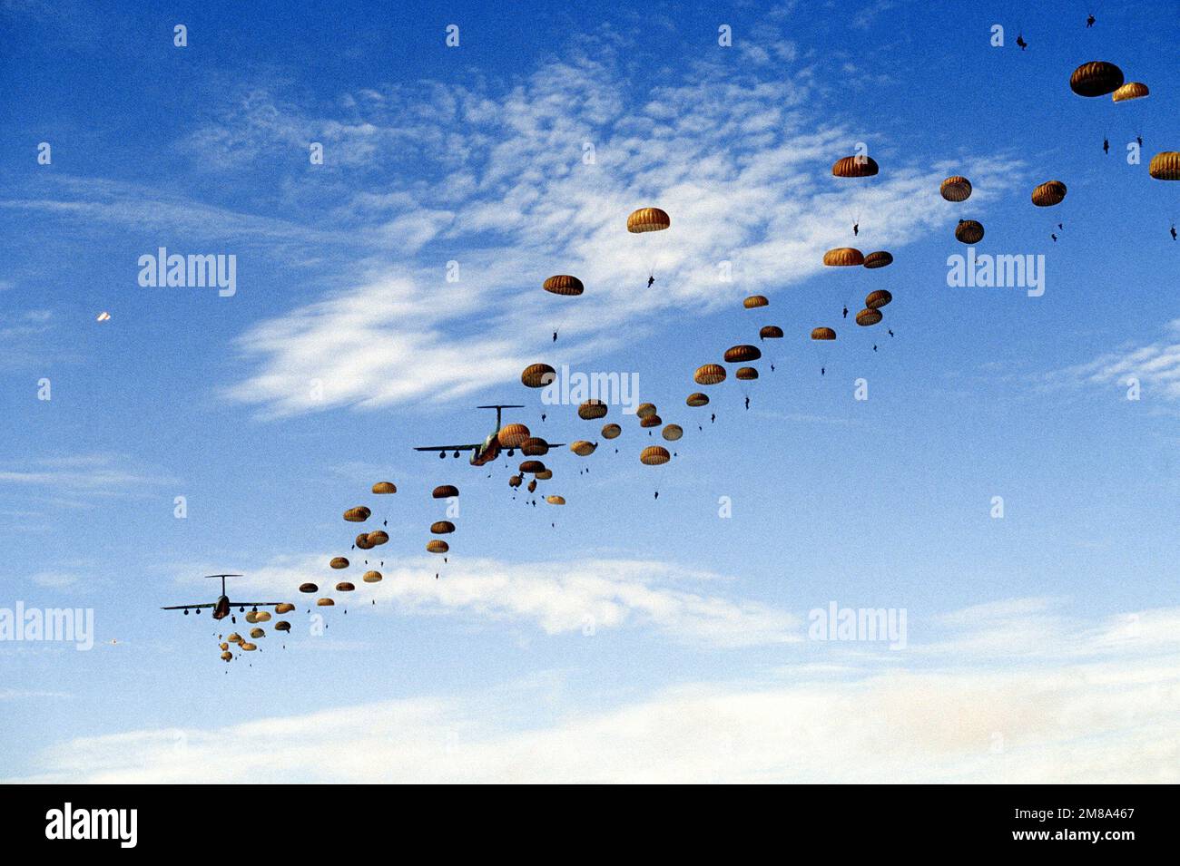 Two groups of paratroopers from the 82nd Airborne Division jump from a ...