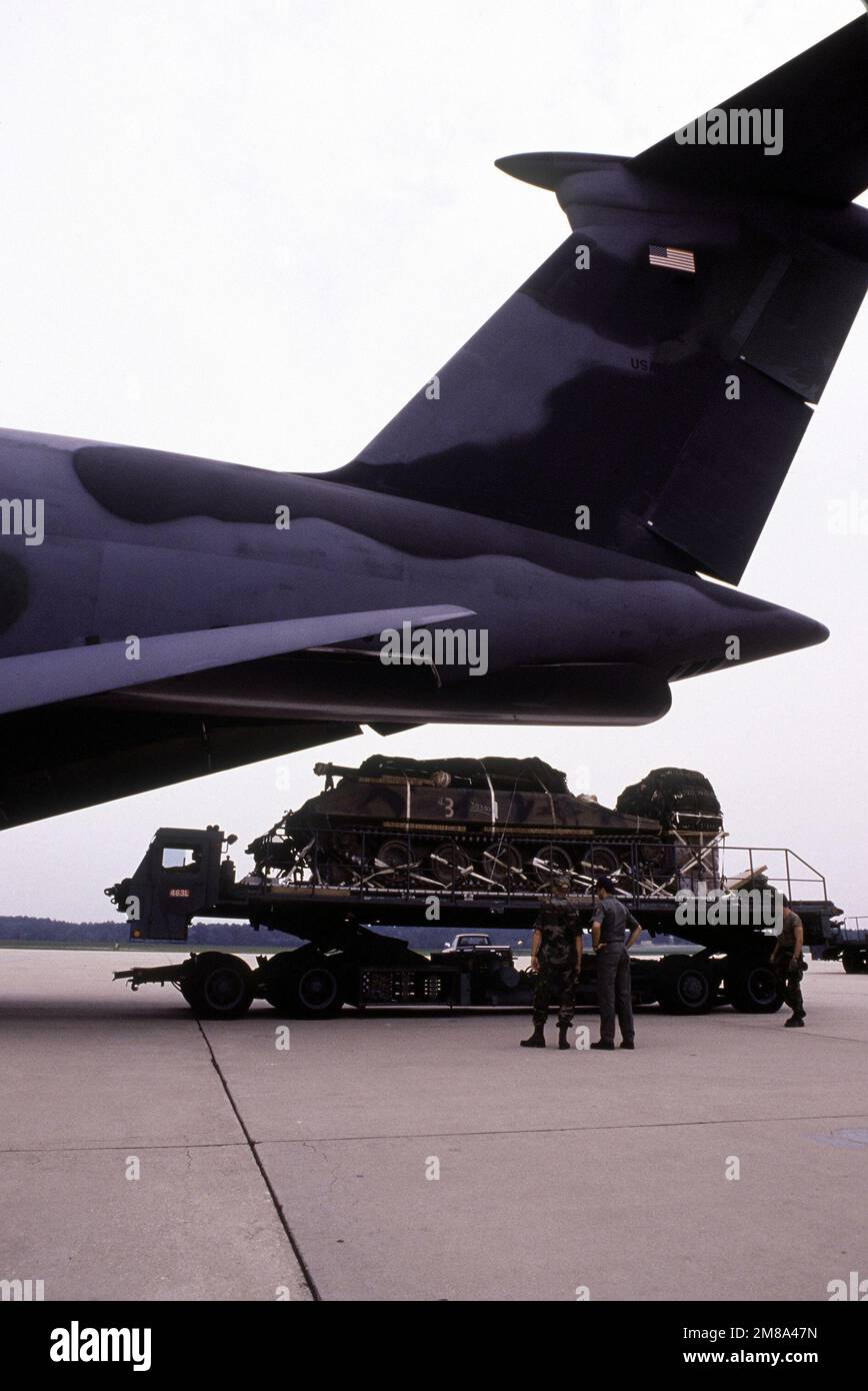 A K-loader transports an M-551 Sheridan light tank to the rear ramp of ...