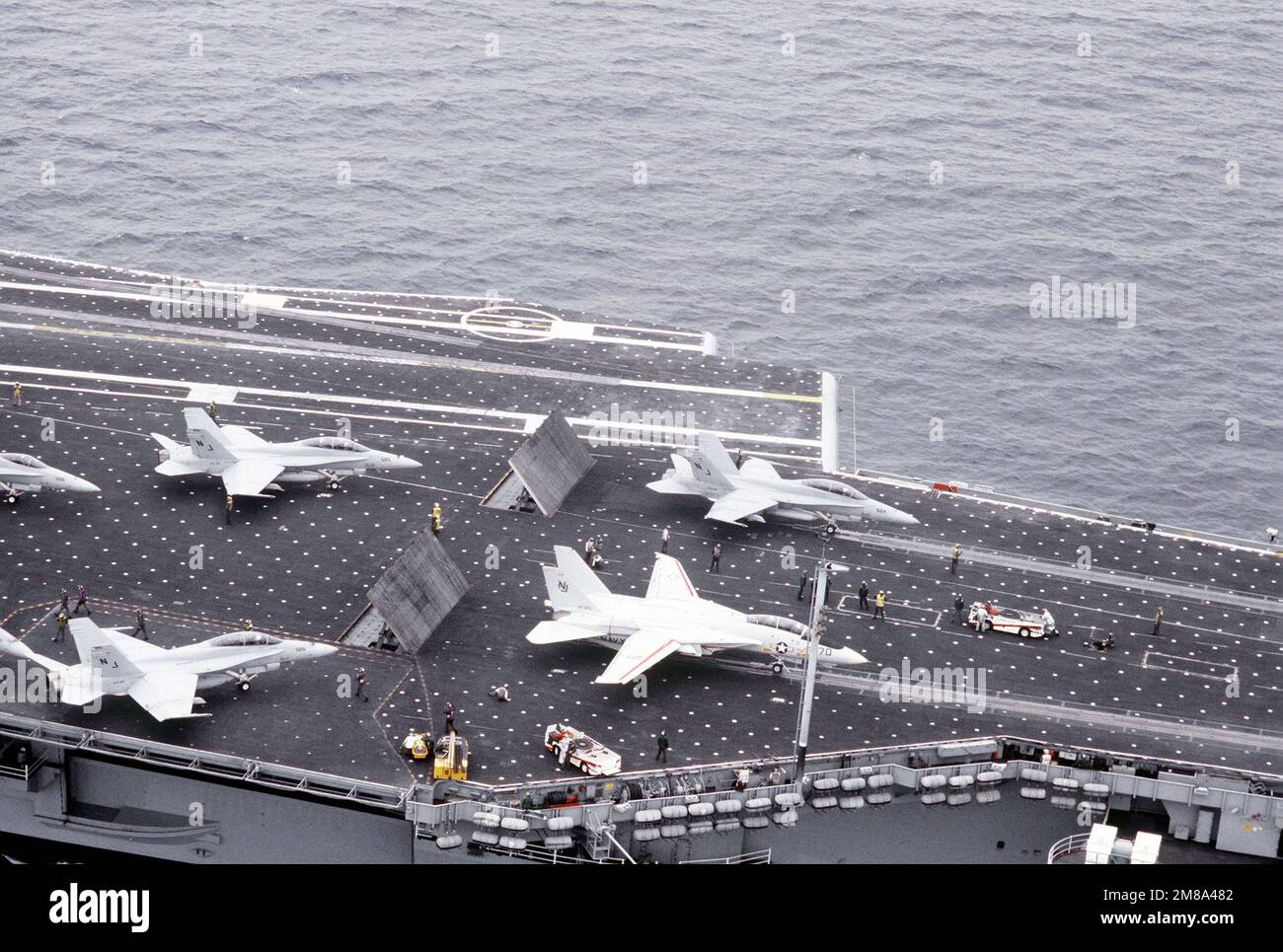F/A-18 Hornet and F-14 Tomcat aircraft prepare for launching on the ...