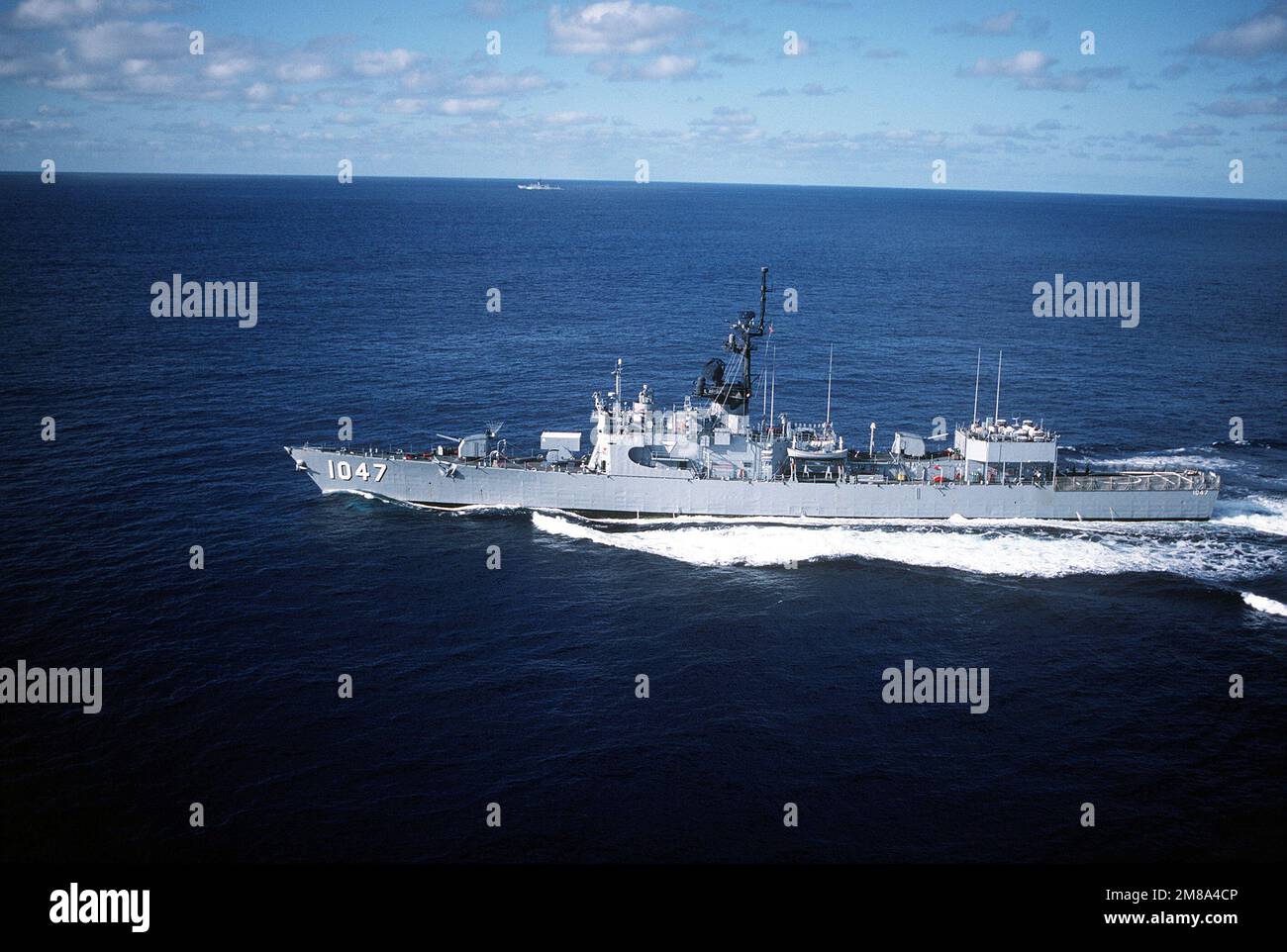 A port beam view of the frigate USS Voge (FF-1047) underway with the ...