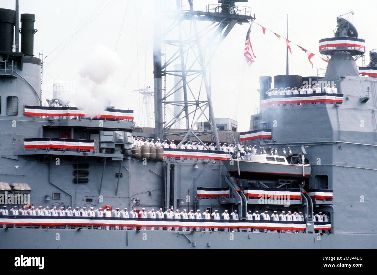 Officers and crewman man the rail during the commissioning ceremony for ...