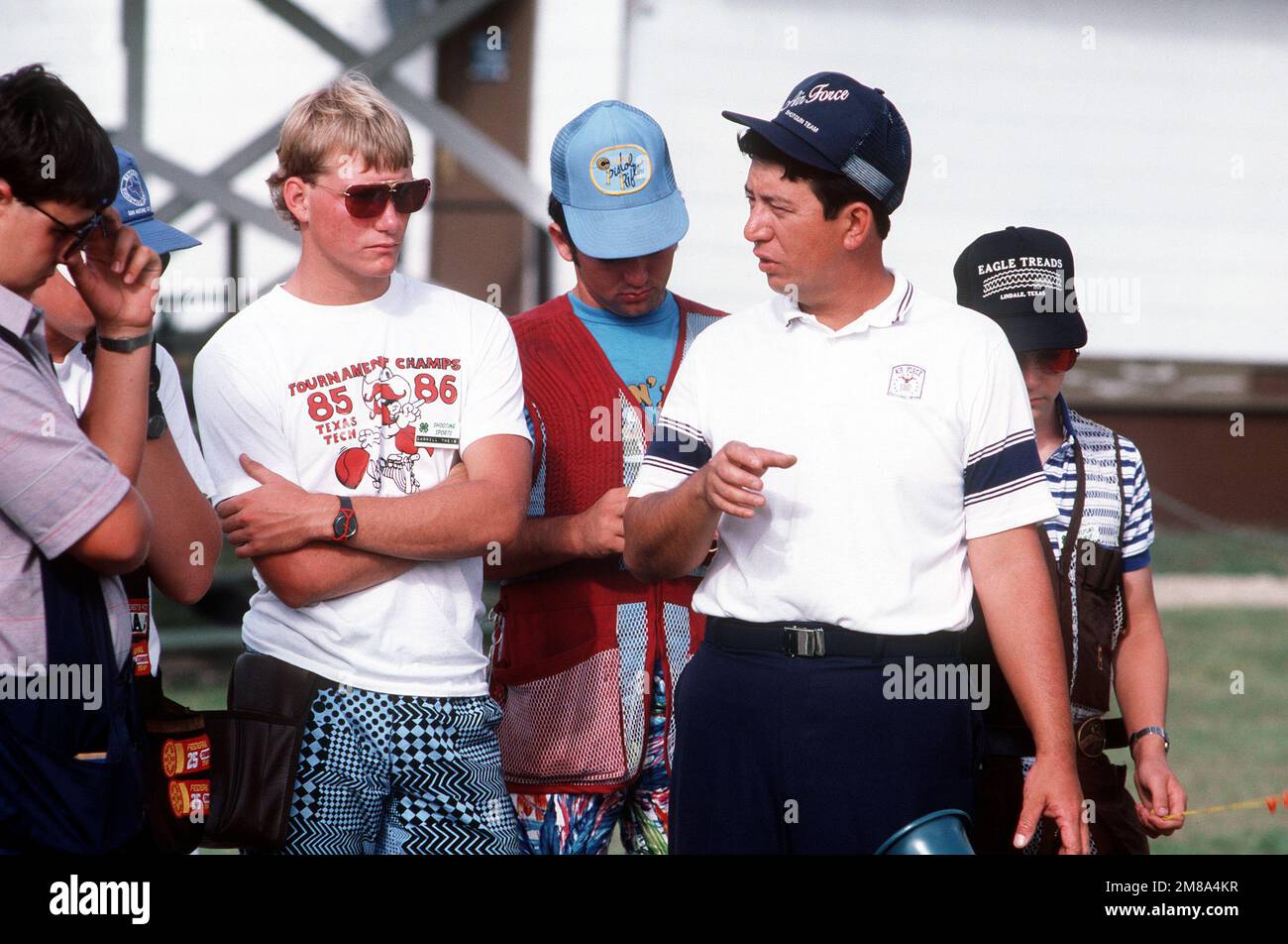 TECH. SGT. Chuck Bautista, a member of the Air Force Shooting Team, coaches a young shooter ...