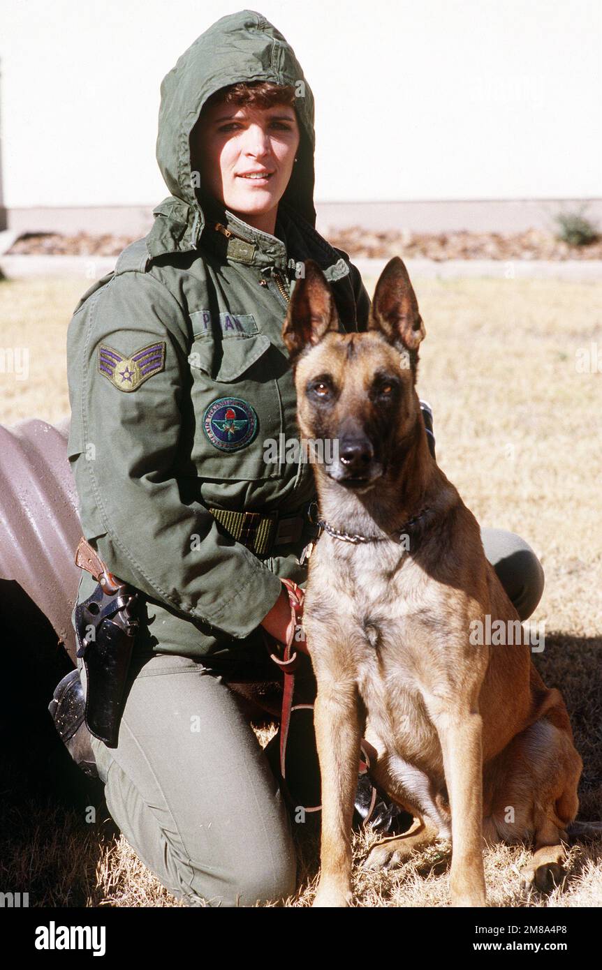 SGT. Michelle Putnam poses for a photograph with her dog Carlos prior ...