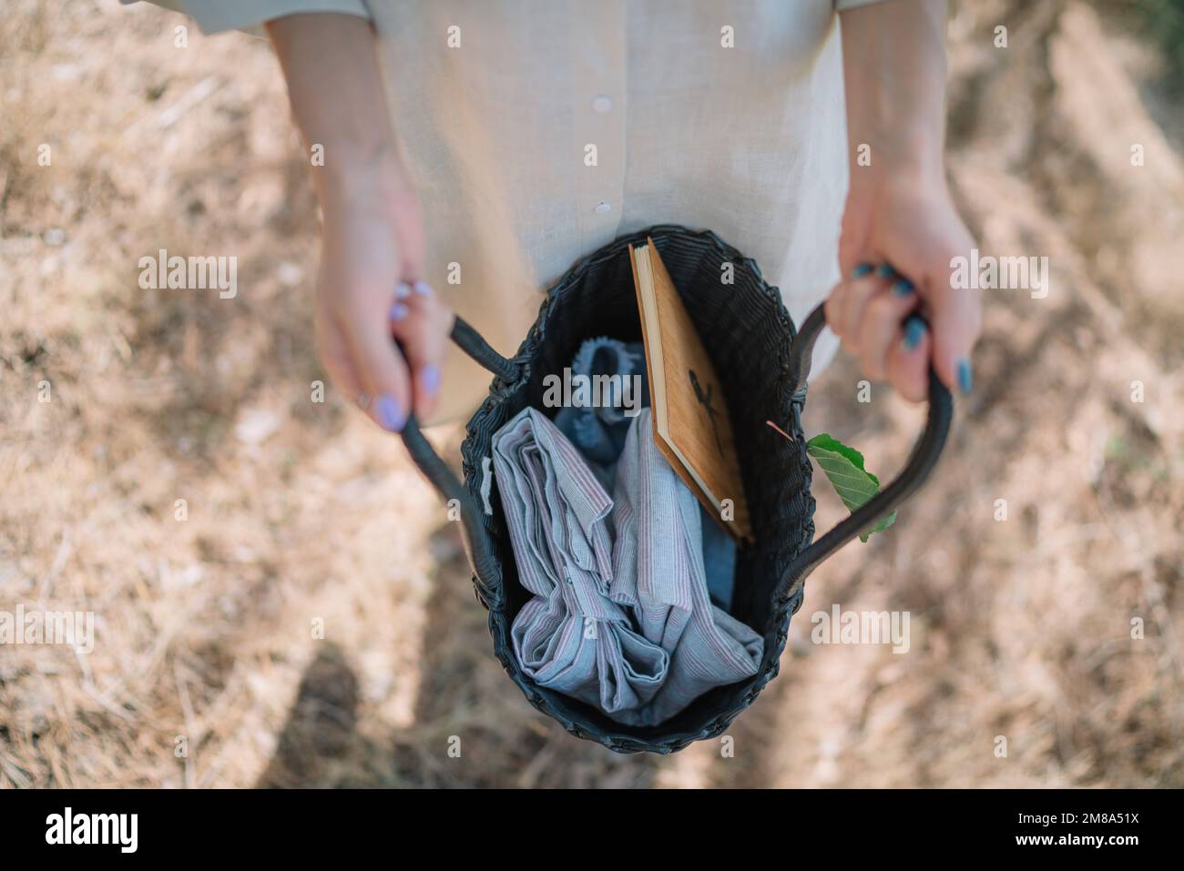 A top view of a girl showing the inside of her bag with clothes and a ...