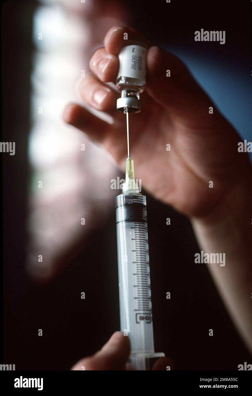 A syringe is prepared for giving immunizations during Gabon Medflag '88 ...
