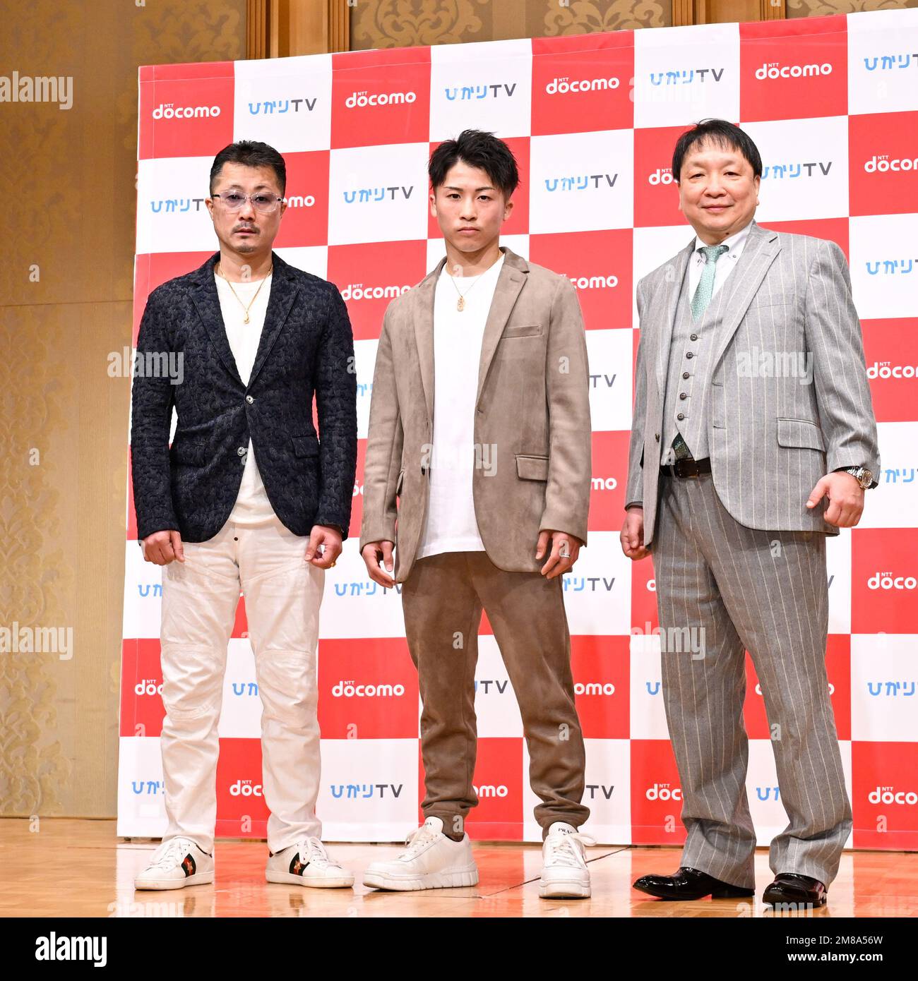 Naoya Inoue (C) attends a press conference with his trainer and father ...