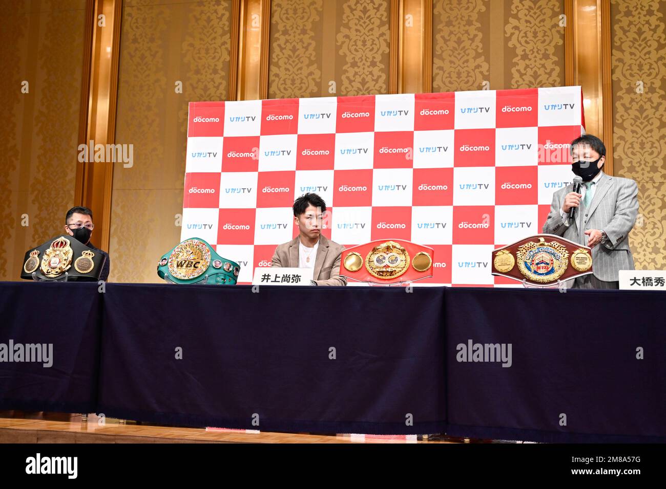 Naoya Inoue (C) attends a press conference with his trainer and father ...