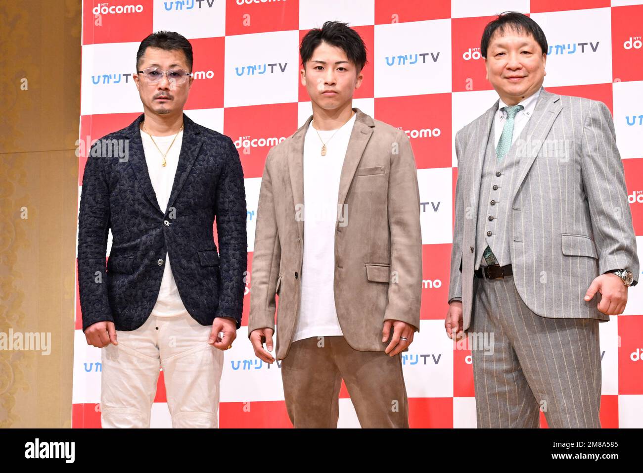 Naoya Inoue (C) attends a press conference with his trainer and father ...