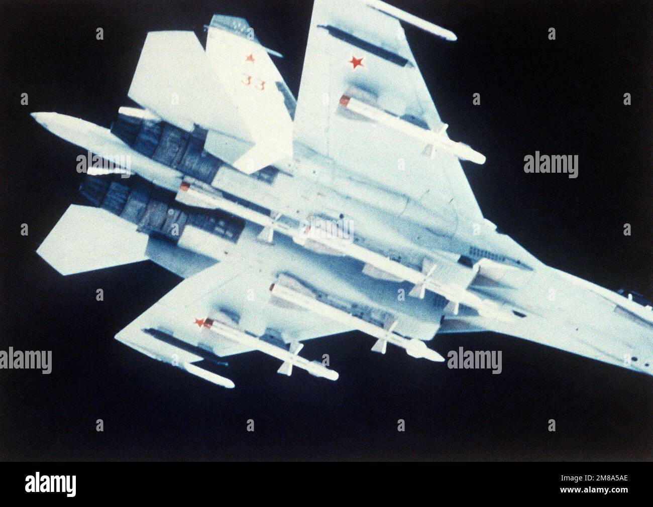 An underside view of a Soviet Su-27 Flanker aircraft carrying AA-10 ...