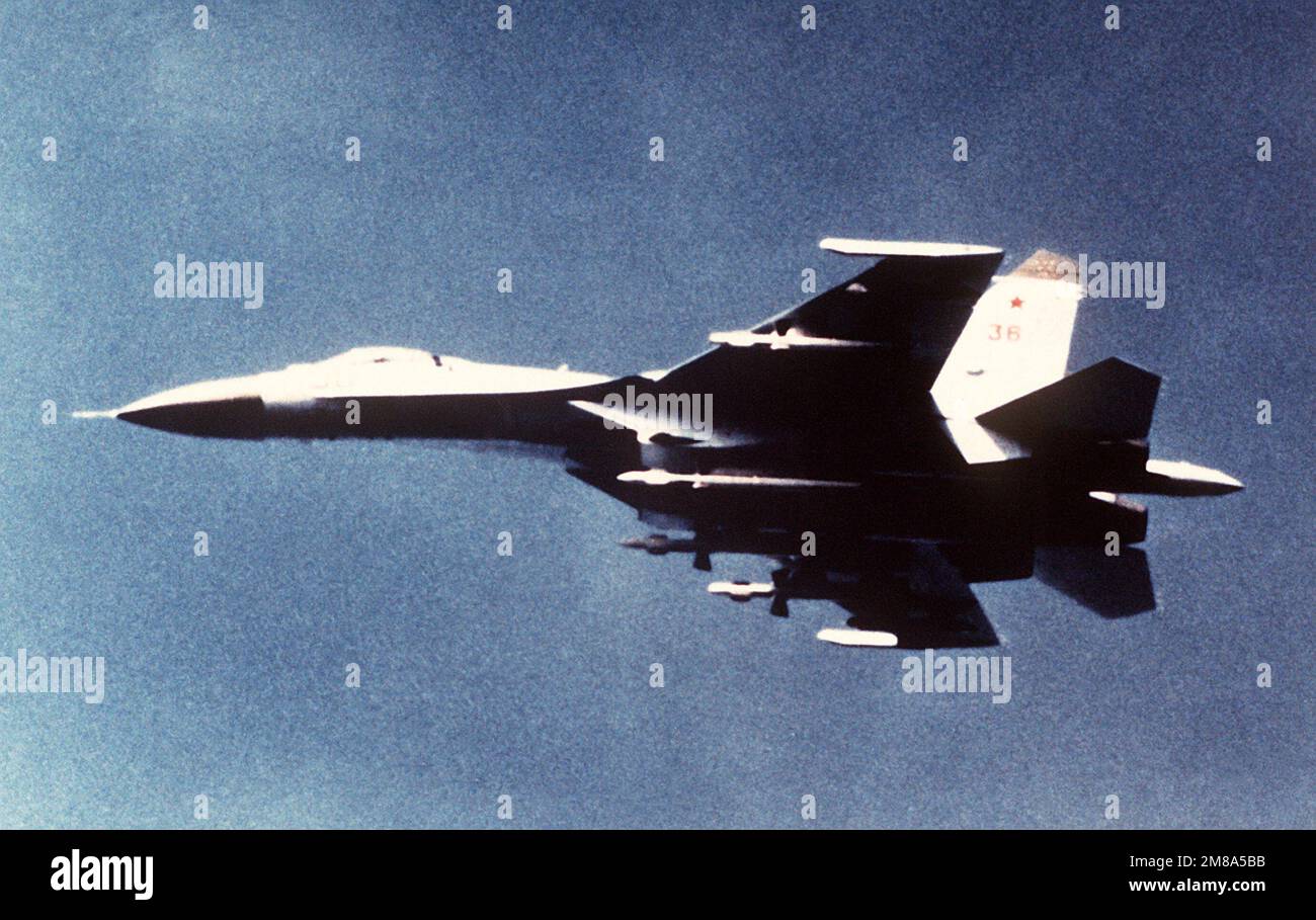 An air-to-air left side view of a Soviet SU-27 Flanker aircraft ...