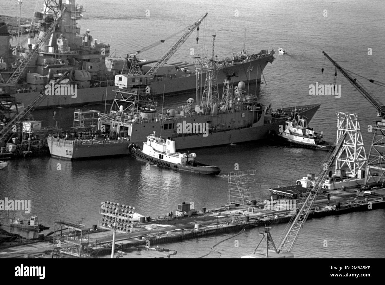 Harbor tugs maneuver the guided missile frigate USS STARK (FFG-31 ...