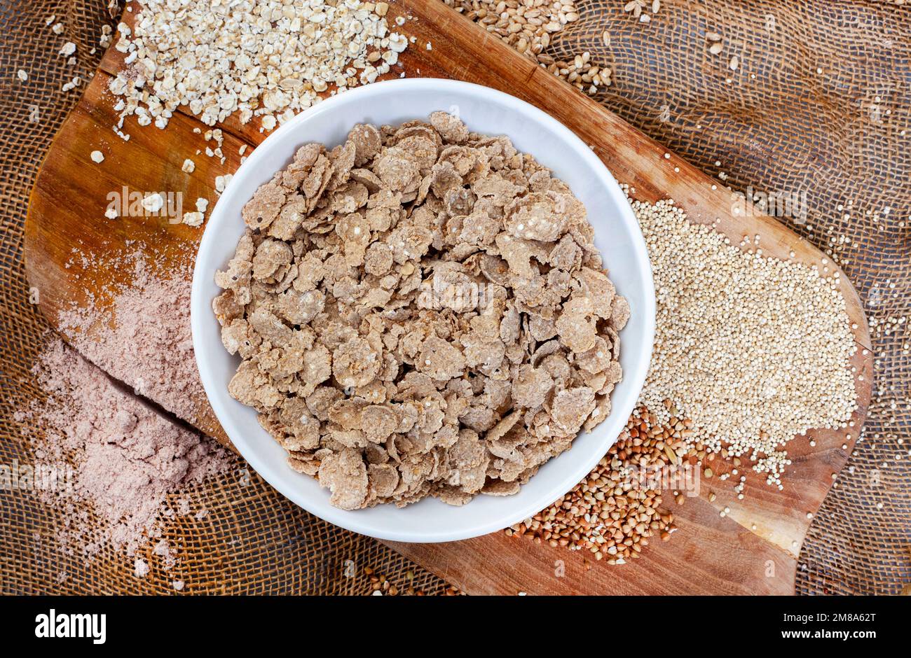 Ancient grain cereal flakes on rustic surface with grains Stock Photo ...