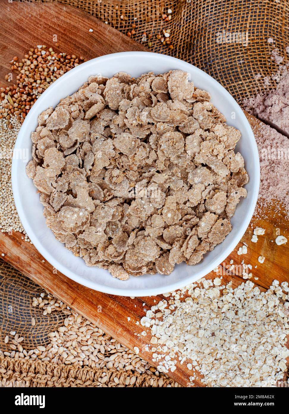Ancient grain cereal flakes on rustic surface with grains Stock Photo ...