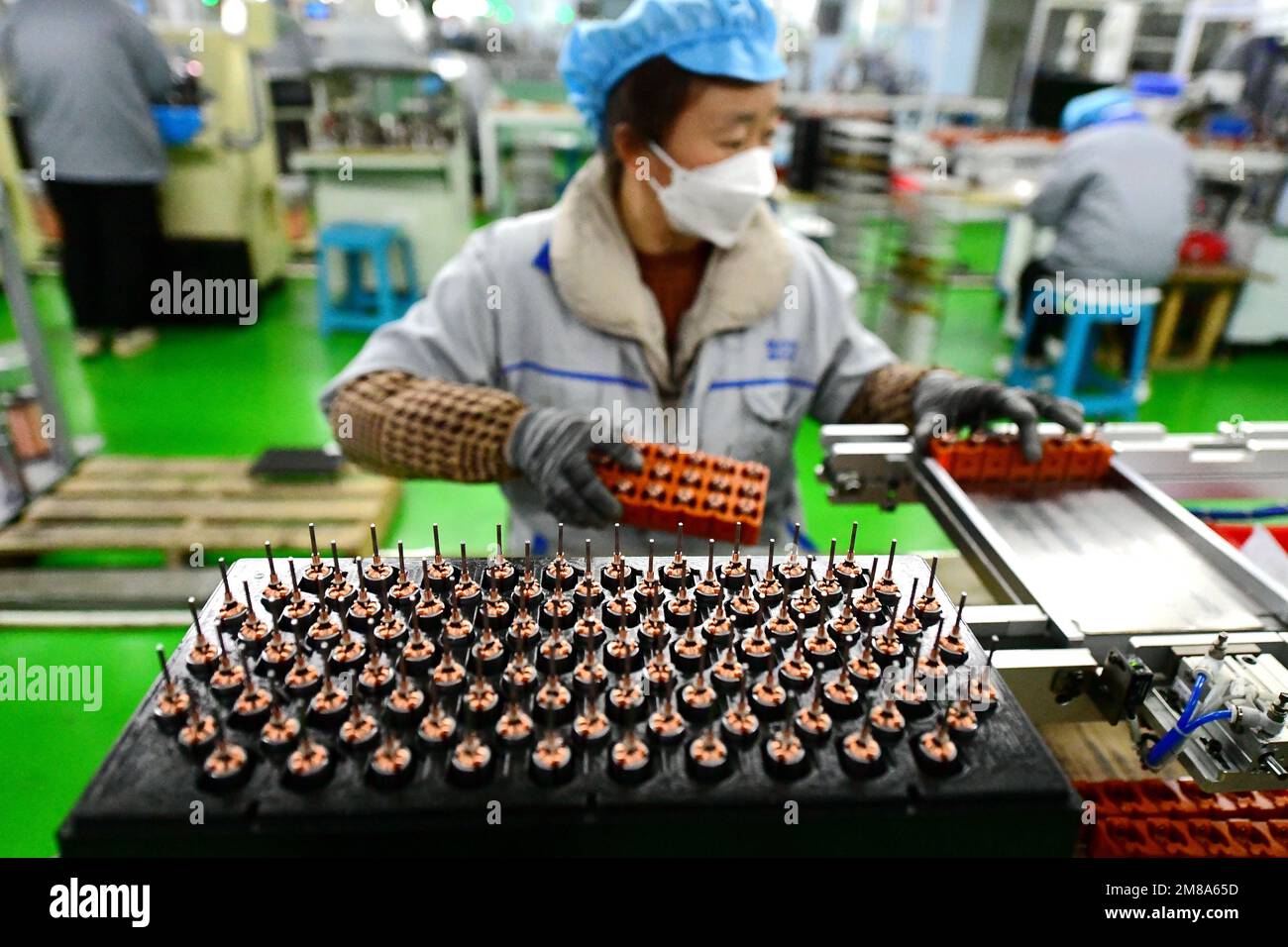 HAI'AN, CHINA - JANUARY 13, 2023 - Workers make miniature DC motors on ...