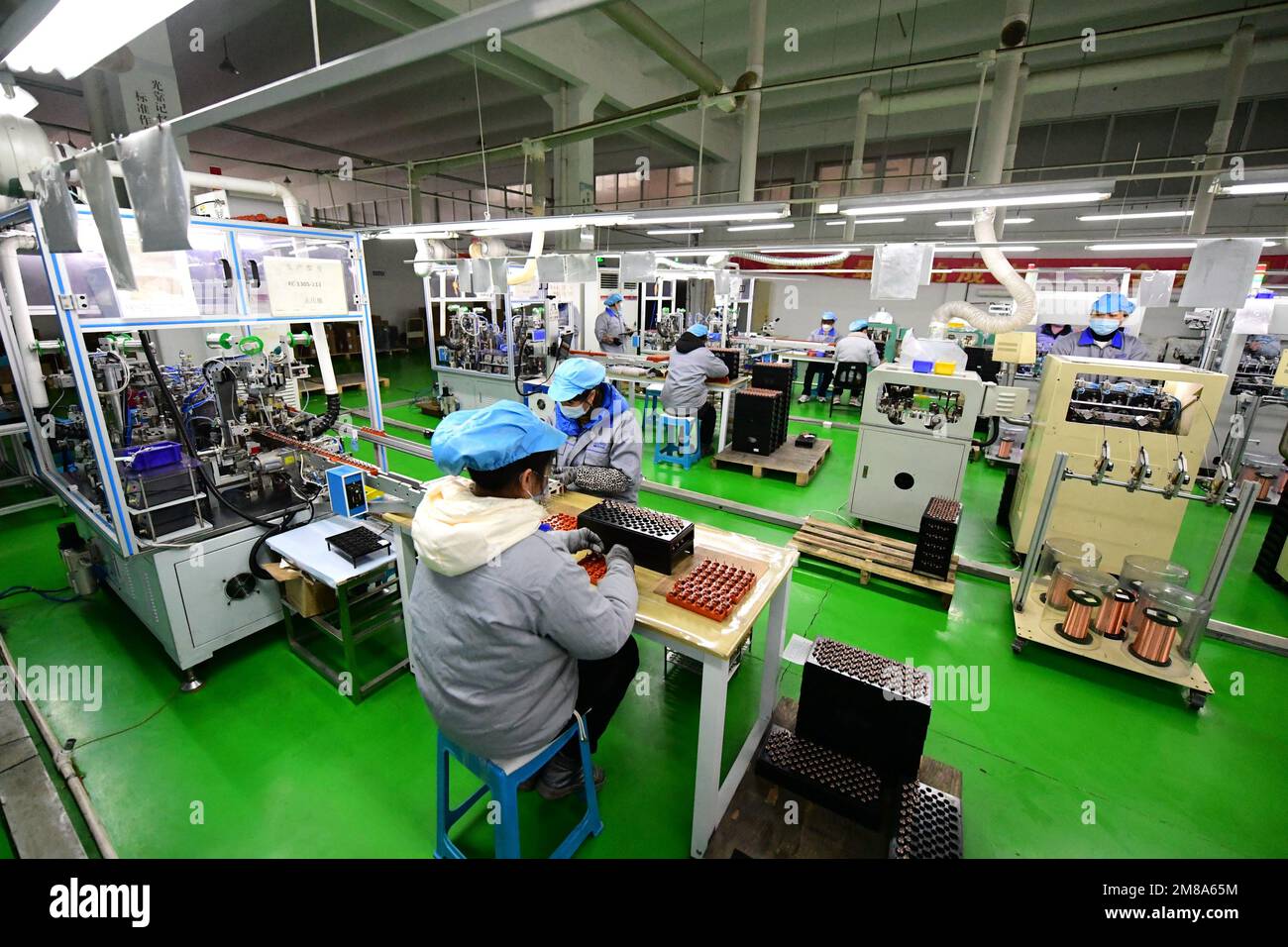 HAI'AN, CHINA - JANUARY 13, 2023 - Workers make miniature DC motors on ...