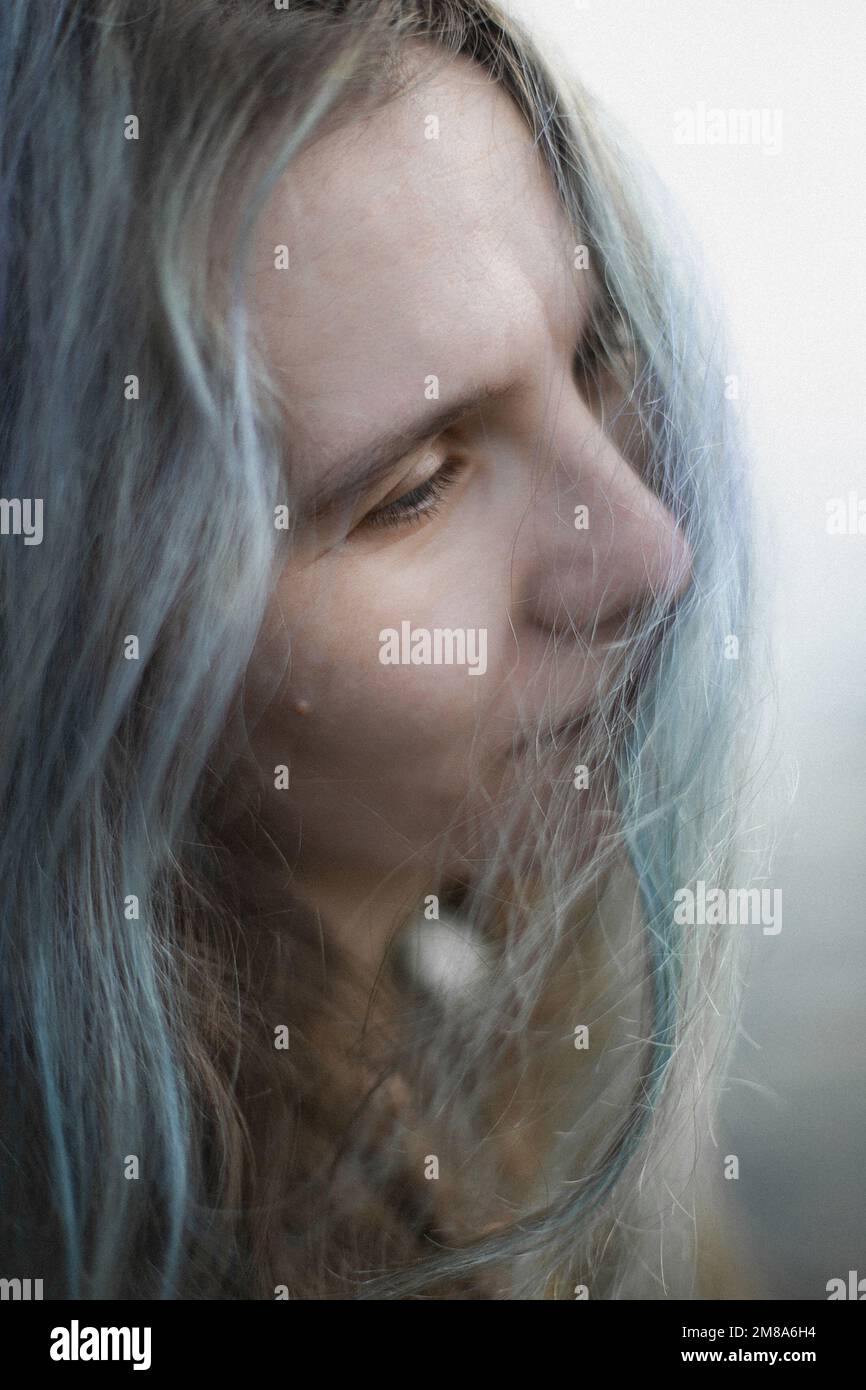 Close Up Thoughtful Gray Haired Woman Tilting Head To Side Portrait