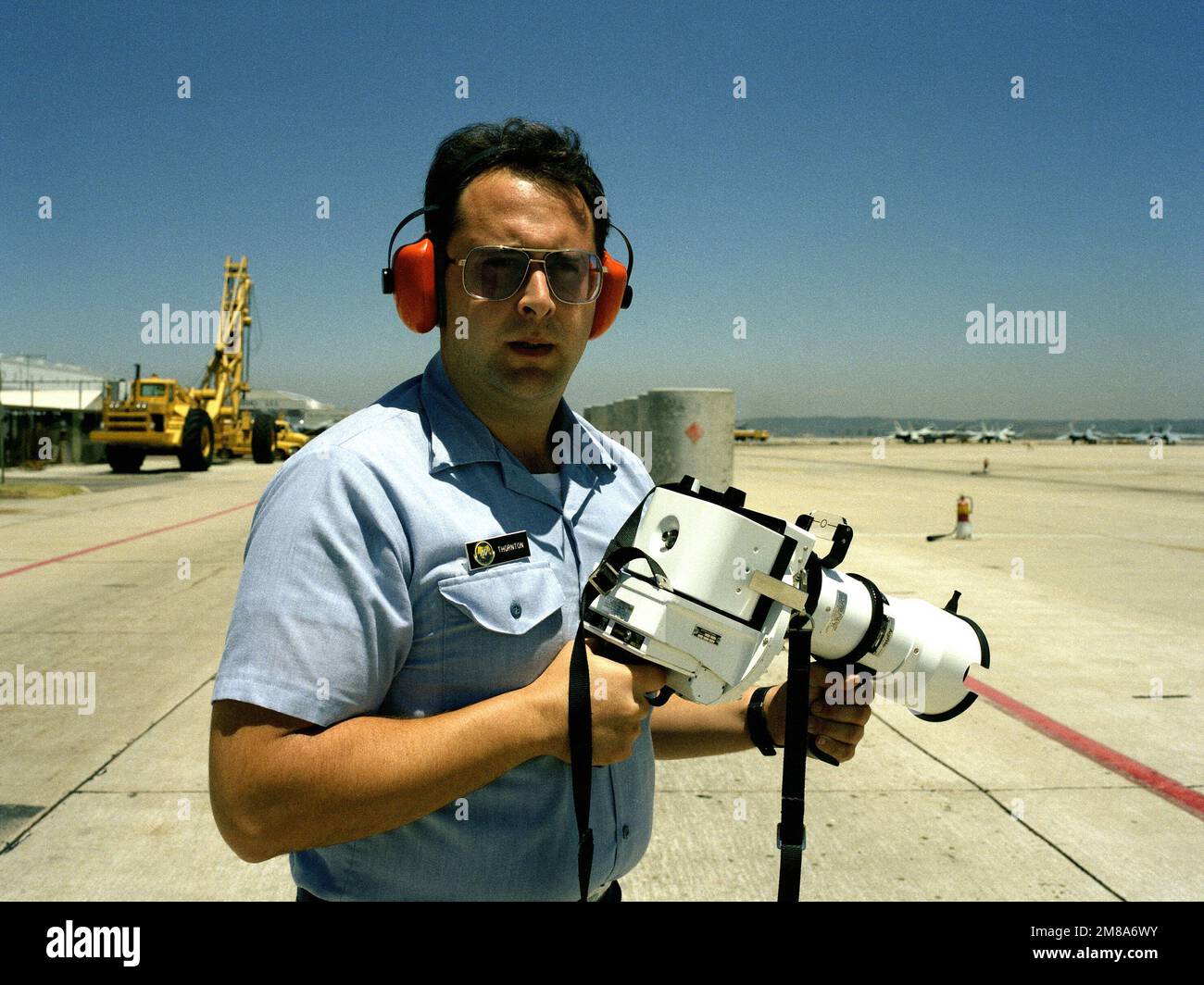A photographer's mate holds a 70 mm Agiflite areial camera. Base: Naval ...