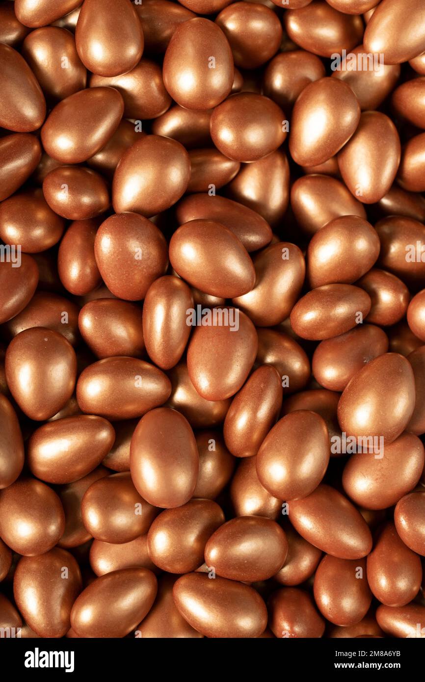 Chocolate dragee in the form of a pile. Brown dragee chocolate with ...