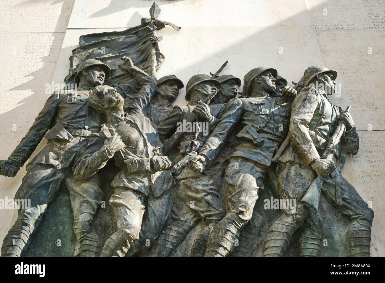 A bronze frieze, sculpture, a memorial to Italian soldiers who fought in WWI. Mounted to the ...