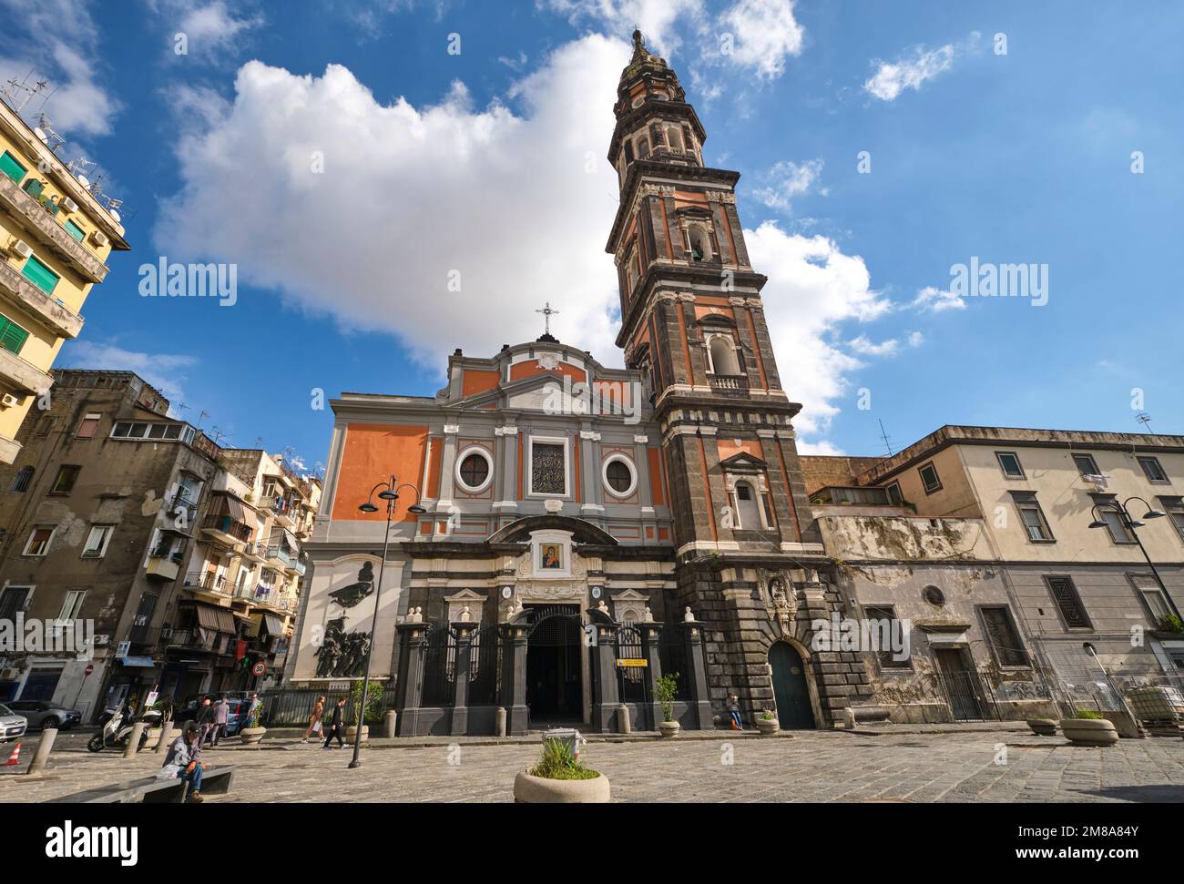 Exterior facade and tall steeple of the Baroque Catholic church ...