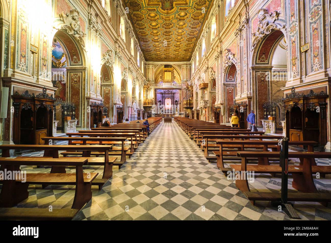 The main aisle, altar and rows of wood pews at the Baroque Catholic ...