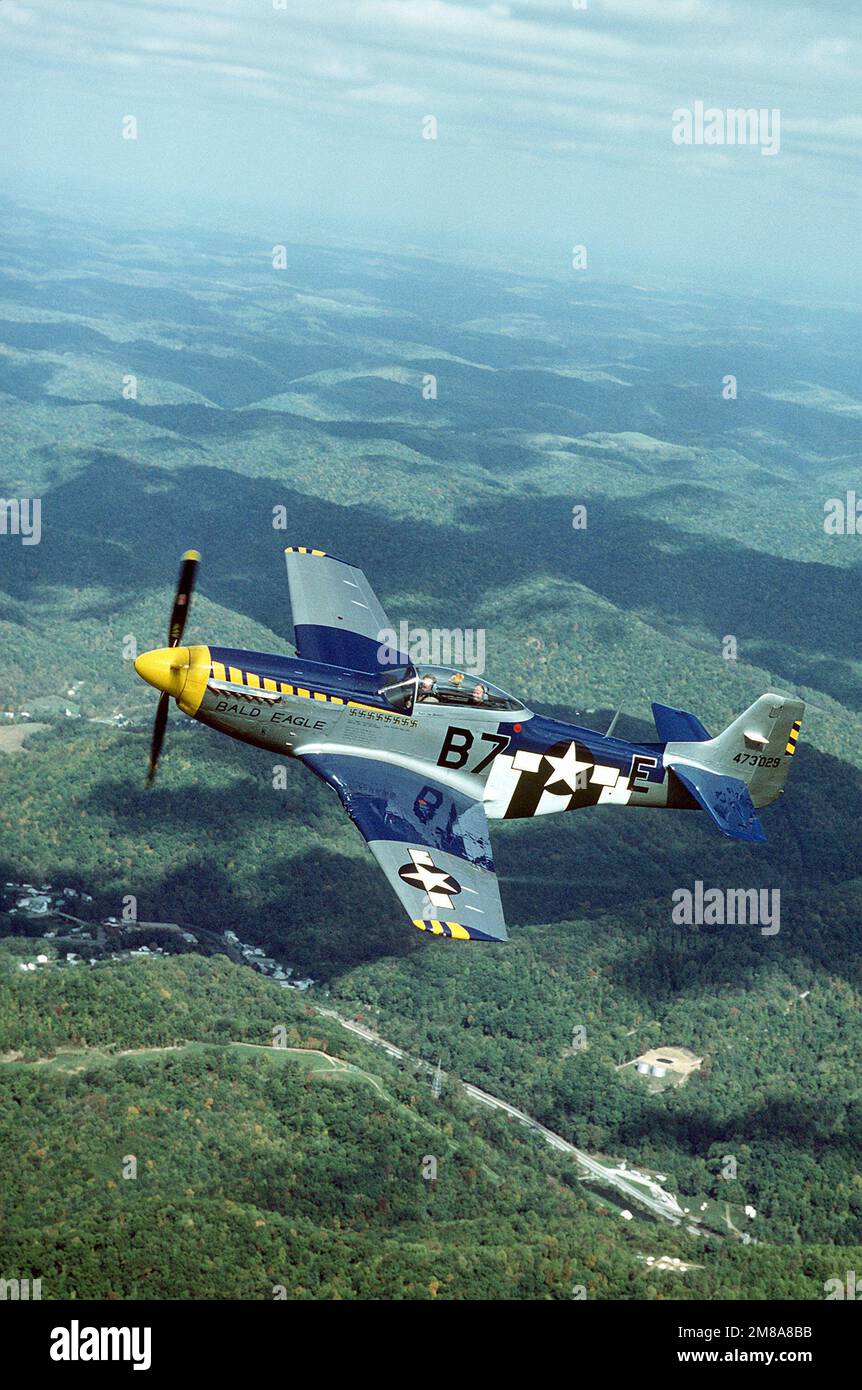 An air-to-air left side view of a two-seater version of a P-51 Mustang ...