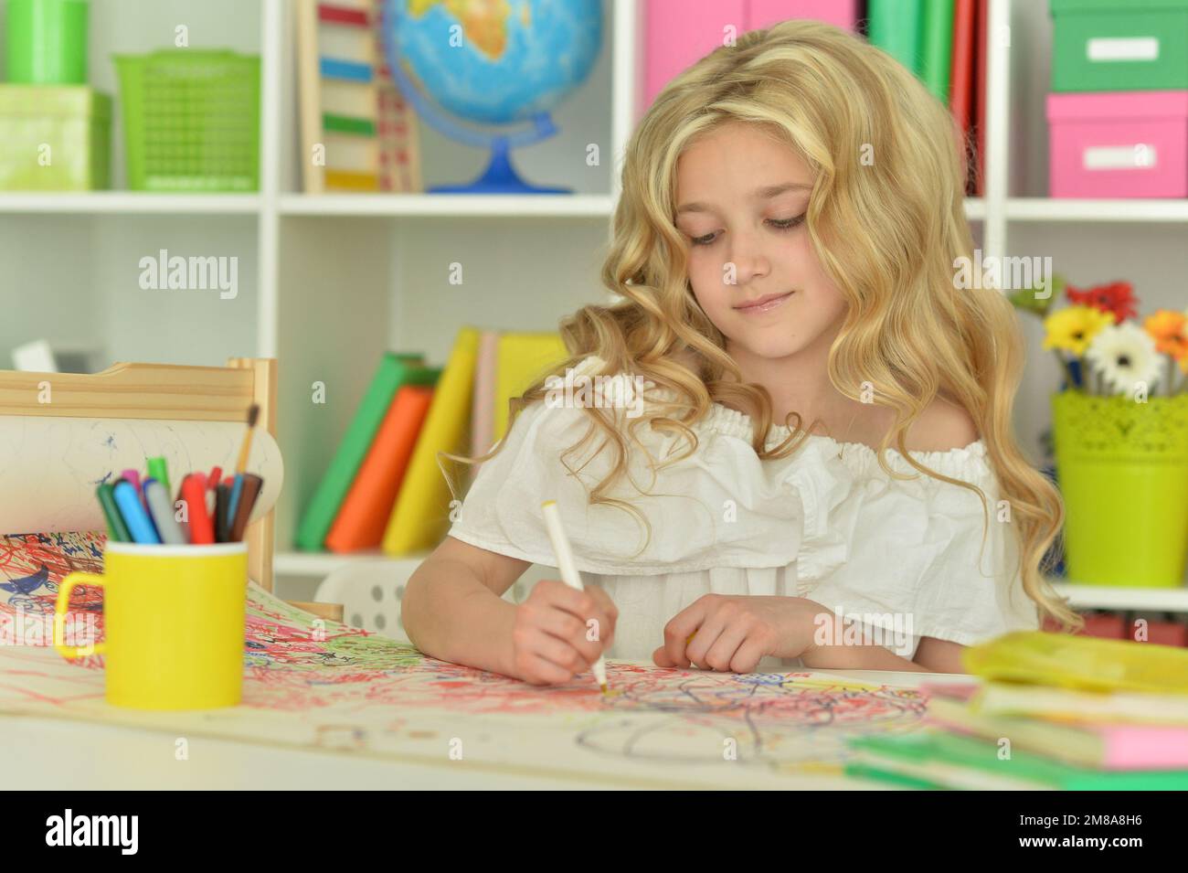 girl drawing picture at desk at home Stock Photo - Alamy