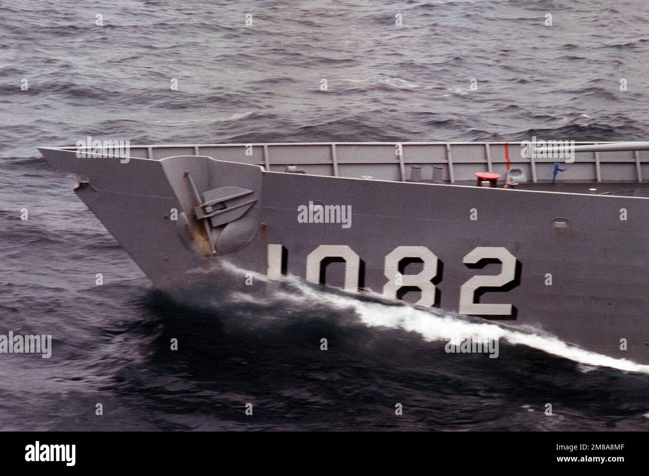 A bow of the frigate USS ELMER MONTGOMERY (FF-1082) plows through heavy ...