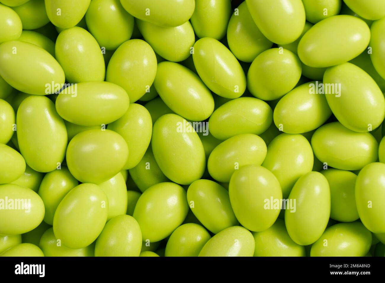 Chocolate dragee in the form of a pile. Green dragee chocolate covered ...