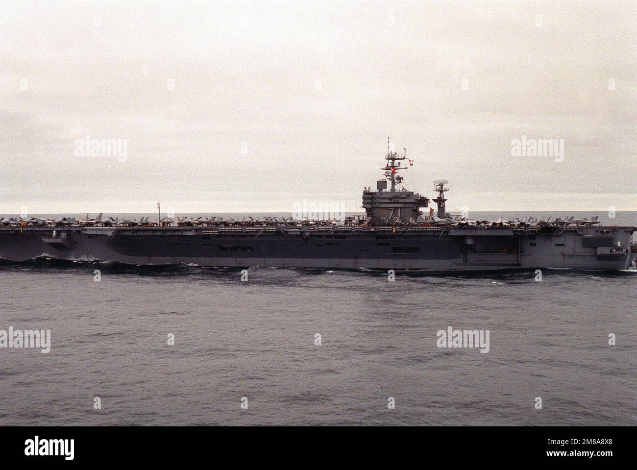A port beam view of the nuclear-powered aircraft carrier USS THEODORE ...