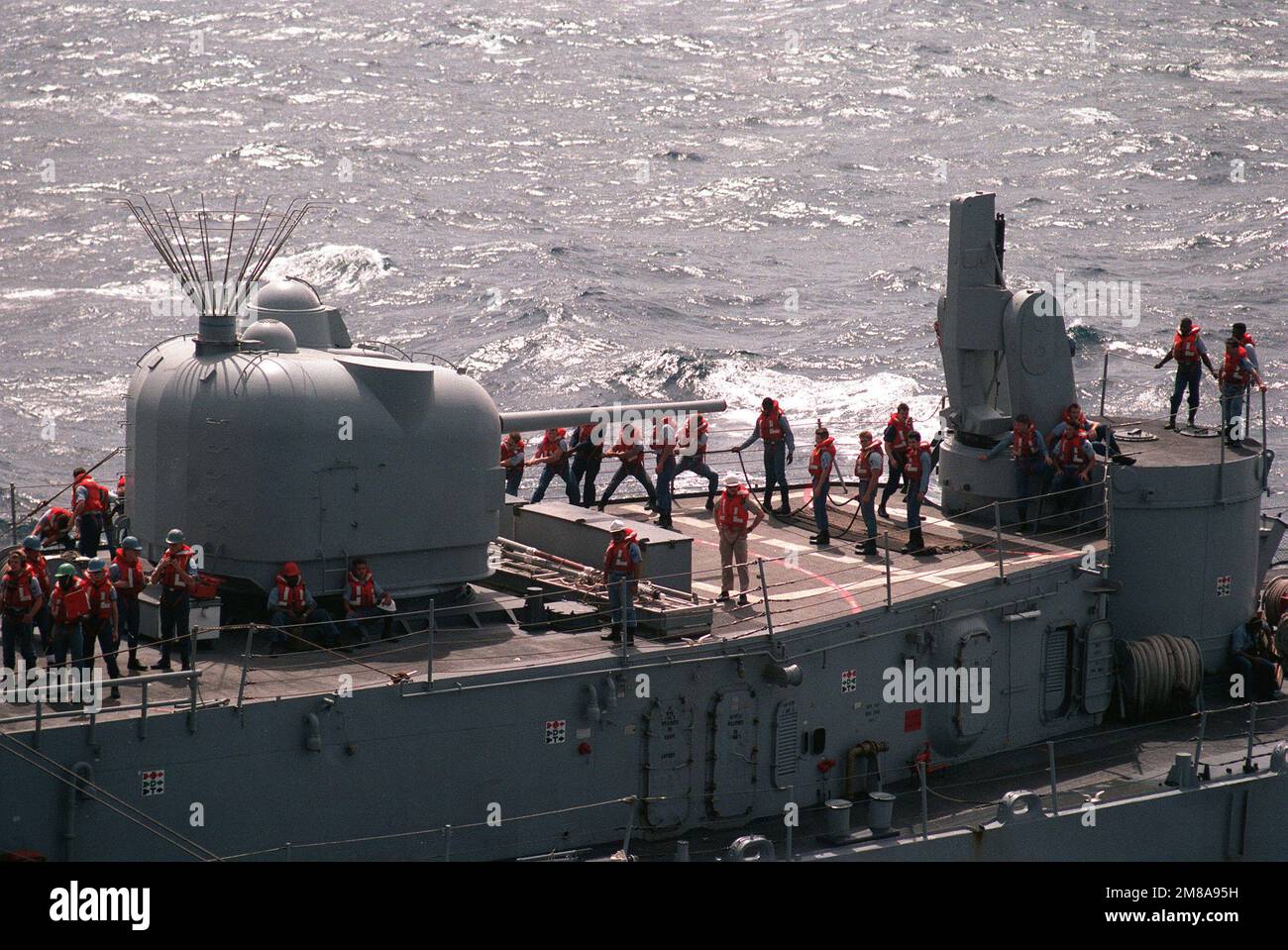 Crewman handle outhaul lines aboard the guided missile destroyer USS ...