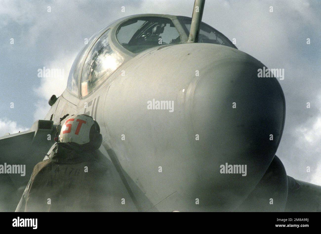 A member of Attack Squadron 176 (VA-176) guides one of his squadron's A ...