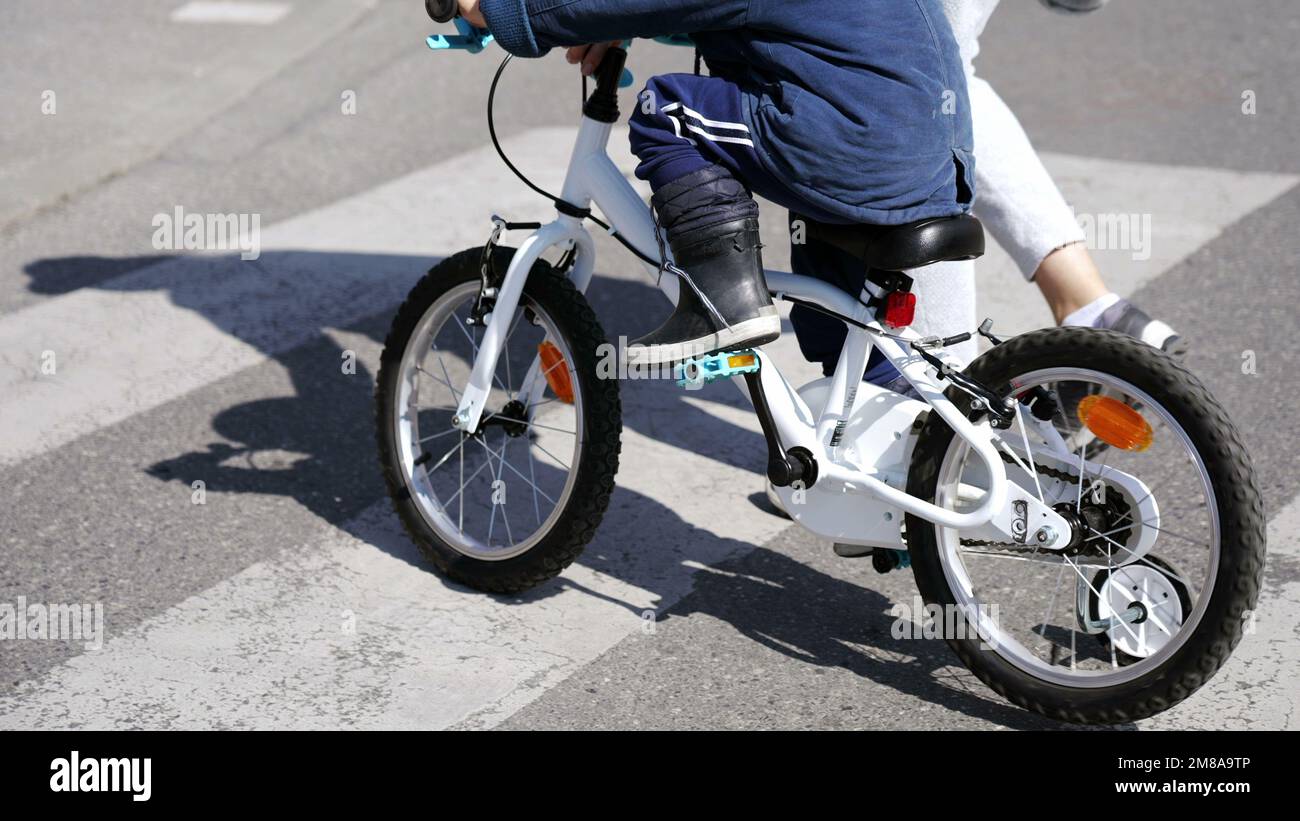 Child crossing street in city crosswalk with mother outdoors Stock ...