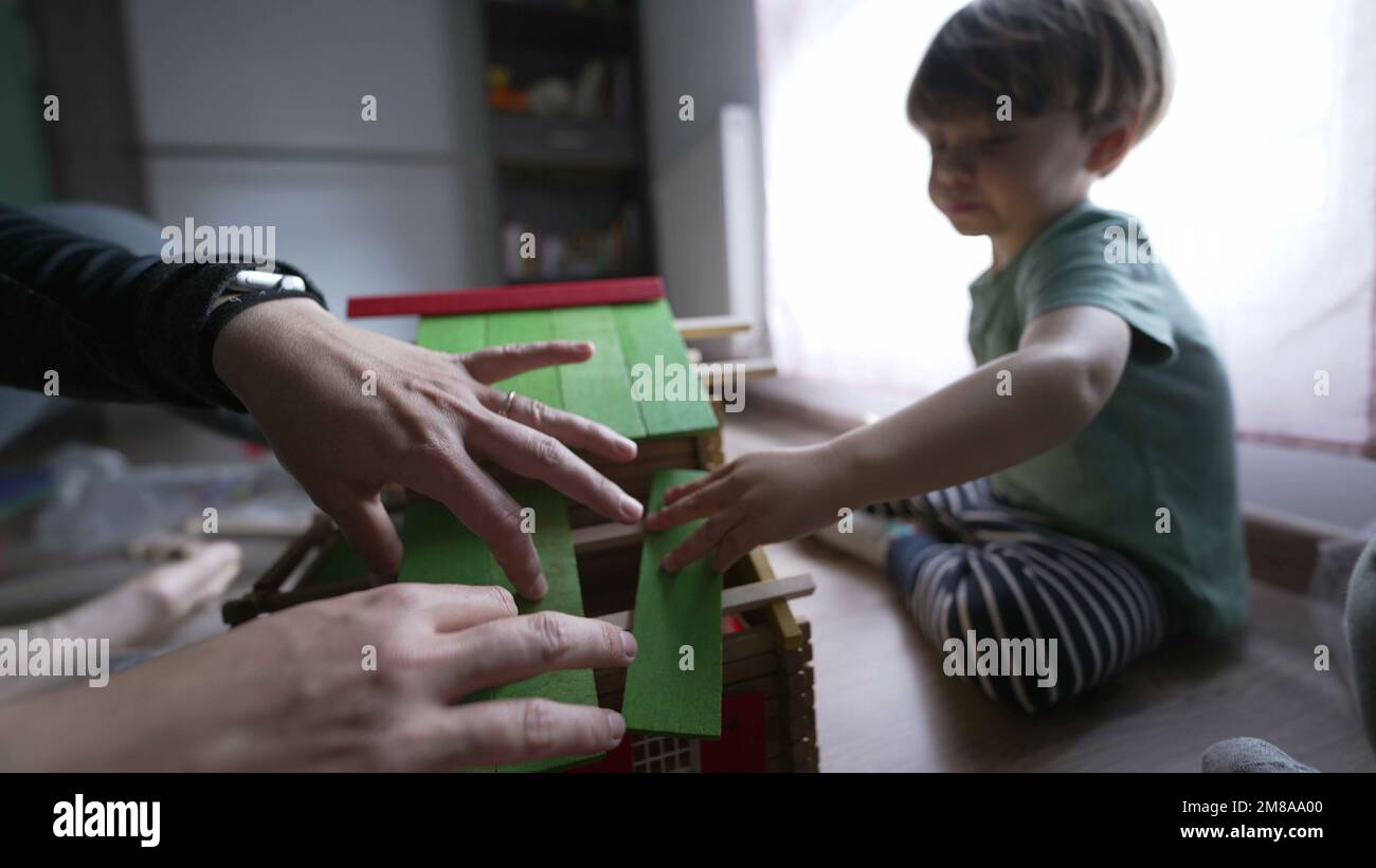 Child learning development at home. Small boy putting wooden ceiling on ...